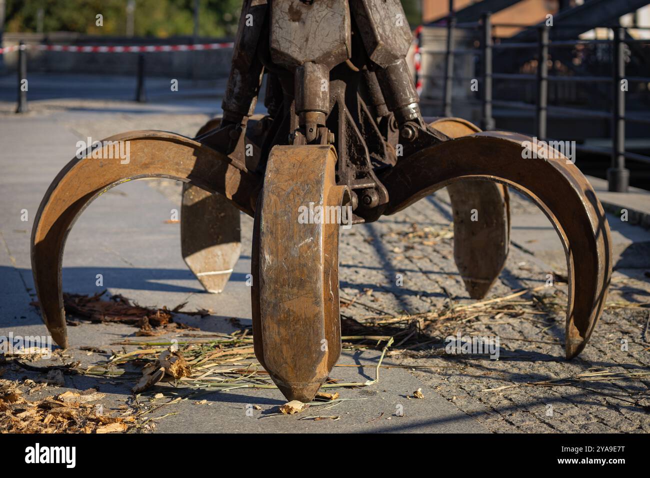 Heavy industrial claw grabber in action, collecting debris and wood on ...