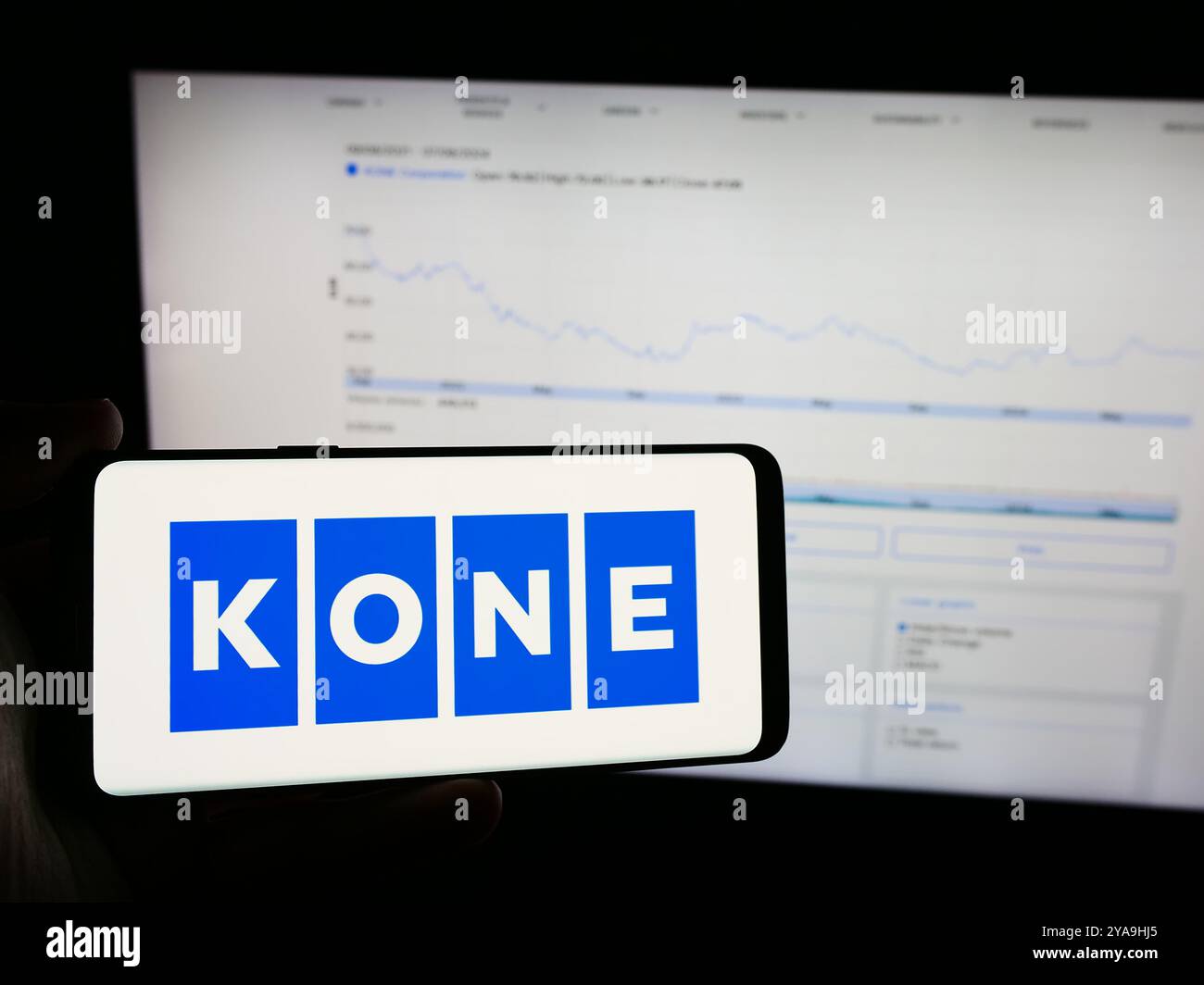 In this photo illustration, a person is holding a mobile phone with the ...