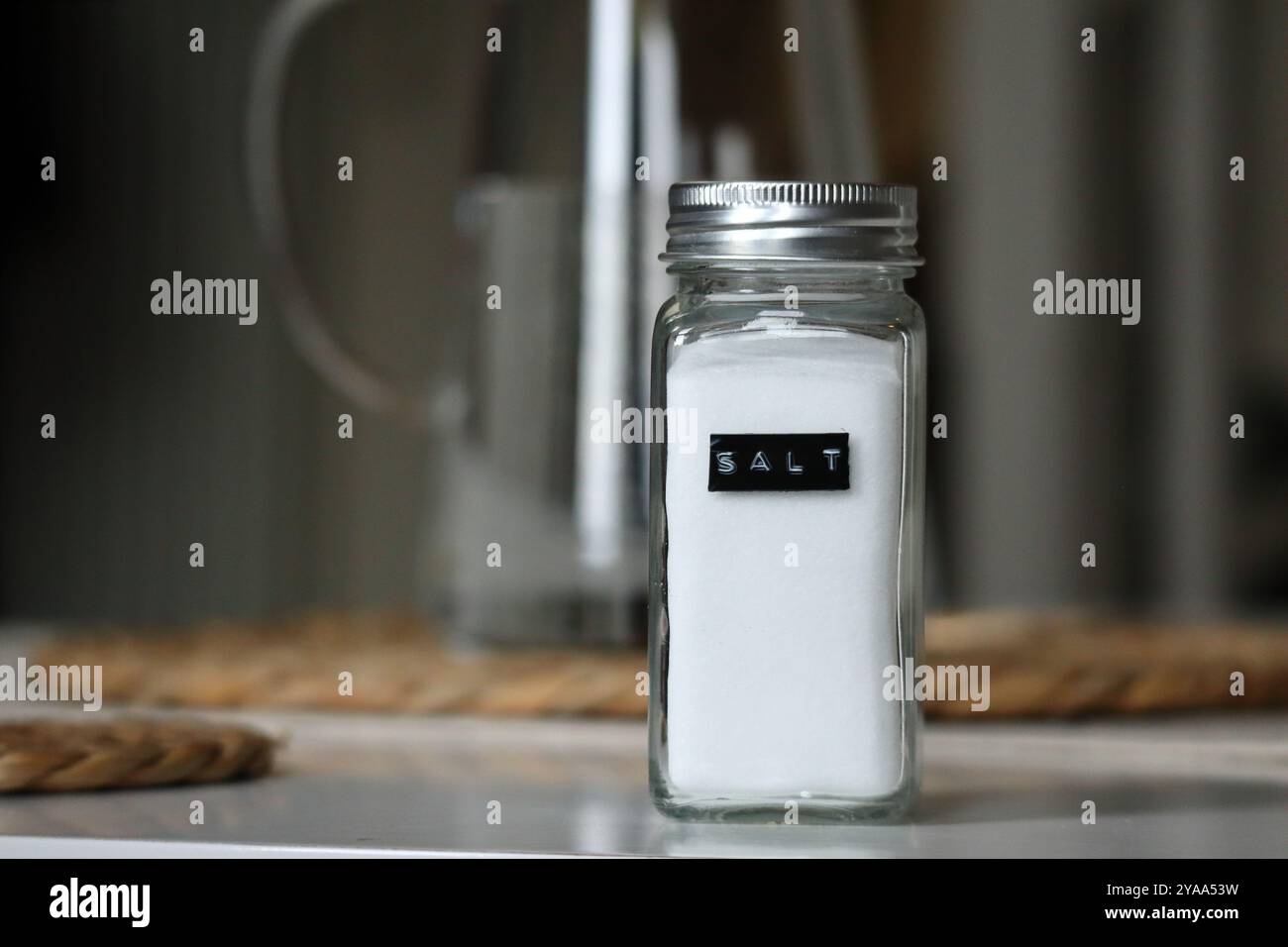 Simple Salt Shaker with Water Jug in Soft Focus Background Stock Photo ...