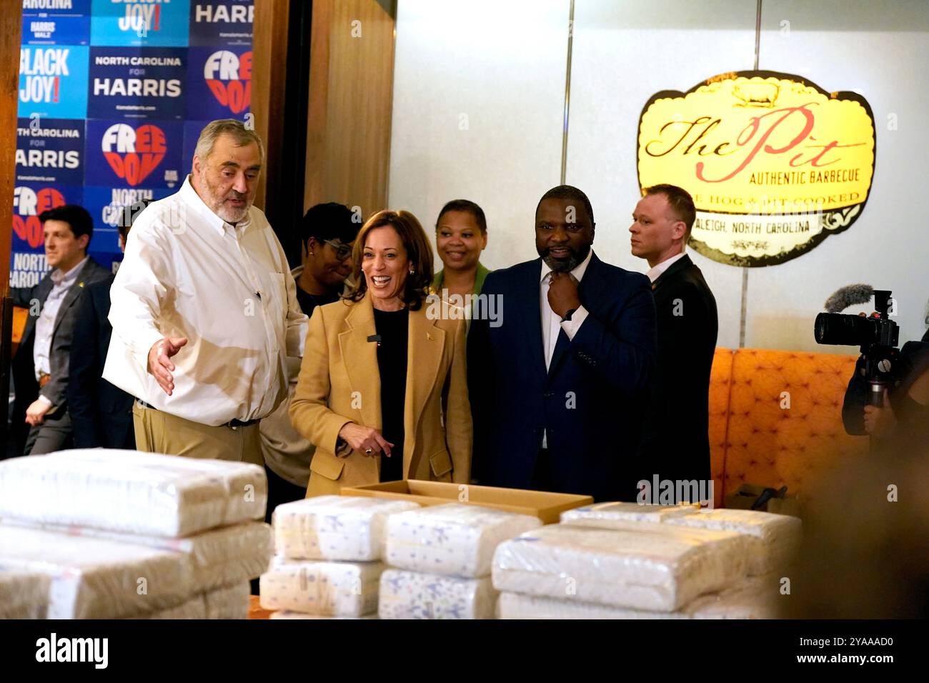 Greg Hatem, owner of The Pit Authentic Barbecue, from left, shows ...