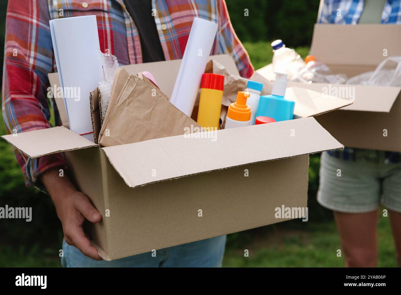 Recycling. People holding cardboard boxes with different garbage ...