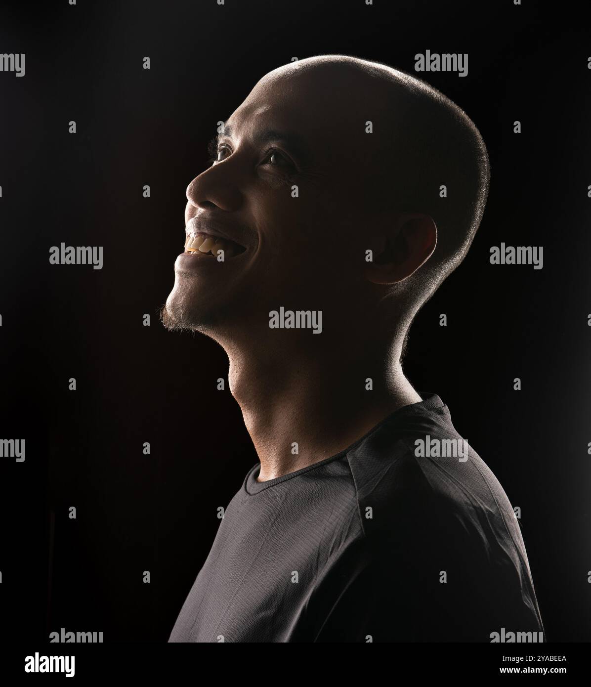 Portrait of a Smiling Man Seen in Profile with Dramatic Lighting ...