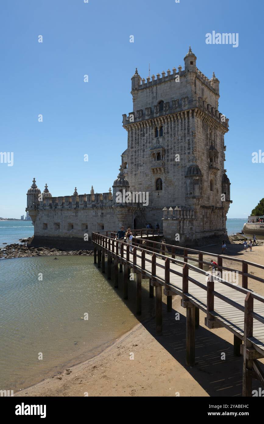Historic stone tower with bridge over water in sunny weather, Torre de ...