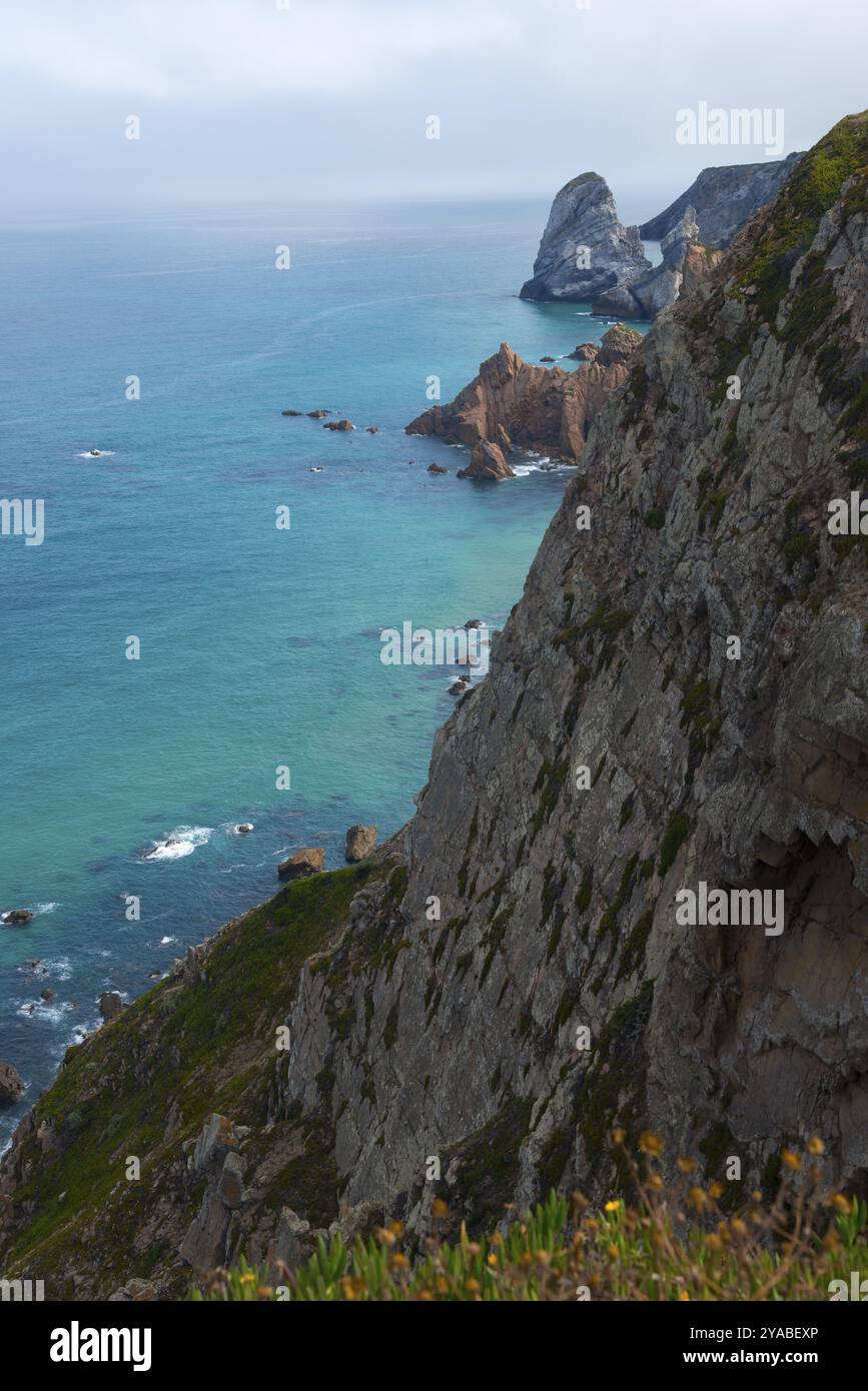 View from a cliff onto the turquoise blue sea and rocky coast, Cape ...