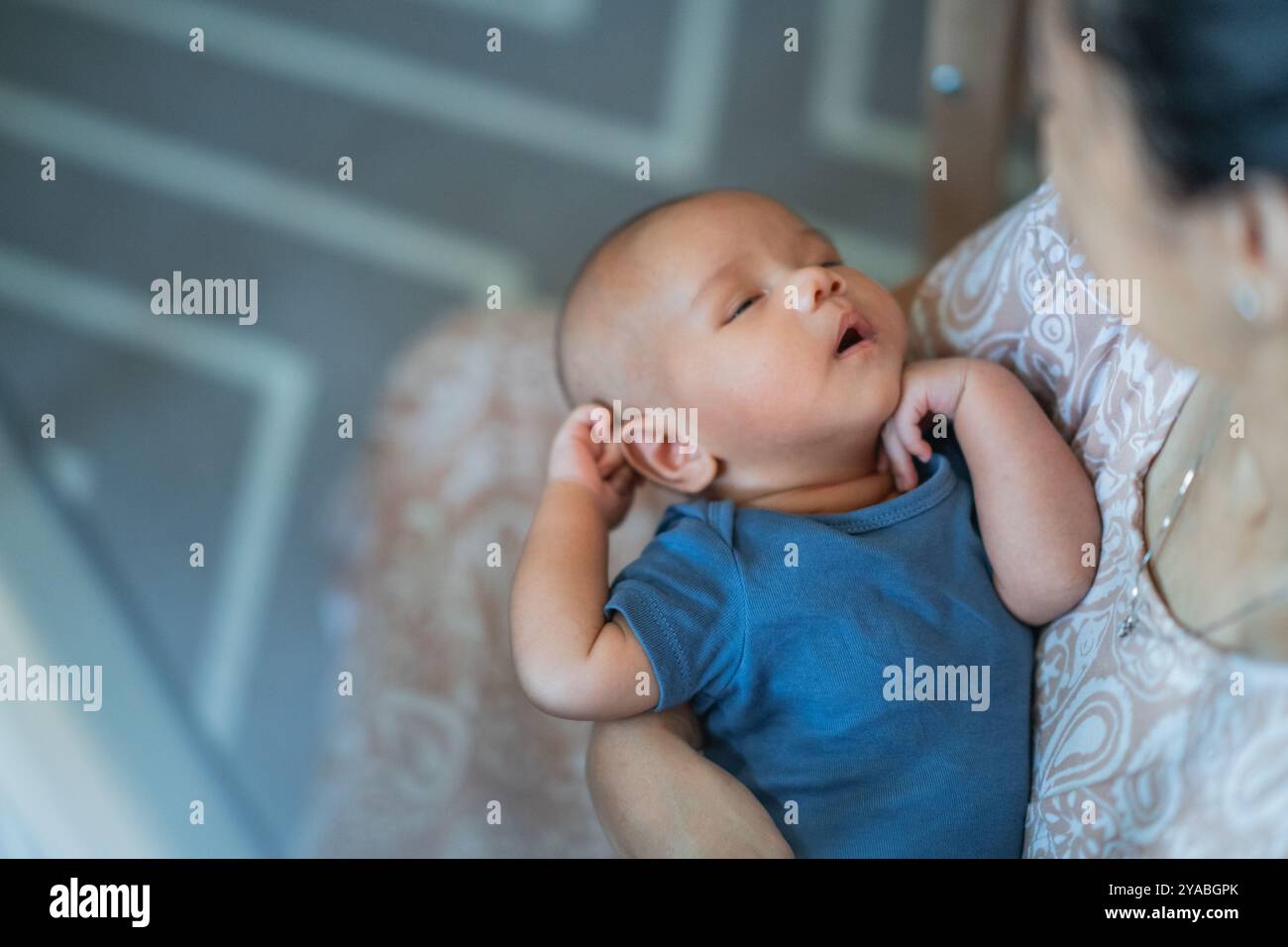 Tender Moment A Loving Mother Cradling Her Sleeping Baby in a Cozy ...