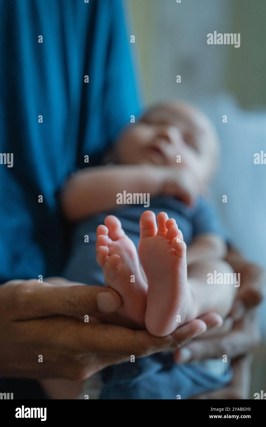 Tiny newborn babys feet in hi-res stock photography and images - Alamy