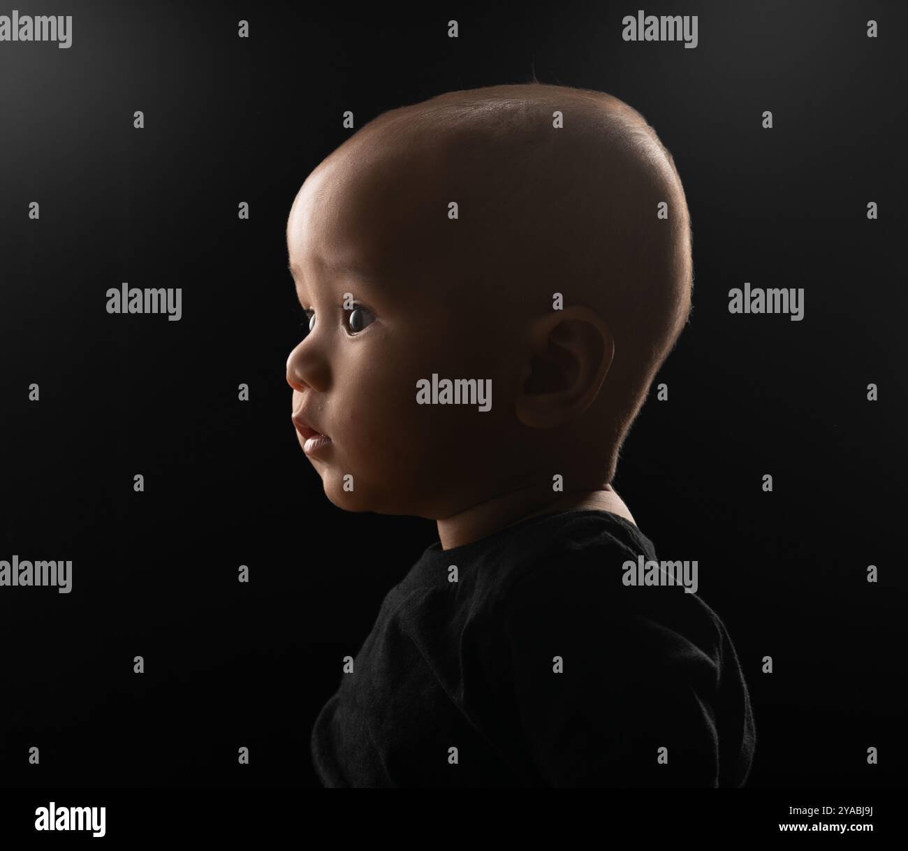 A Profile Portrait Displaying a Thoughtful Child Illuminated by ...