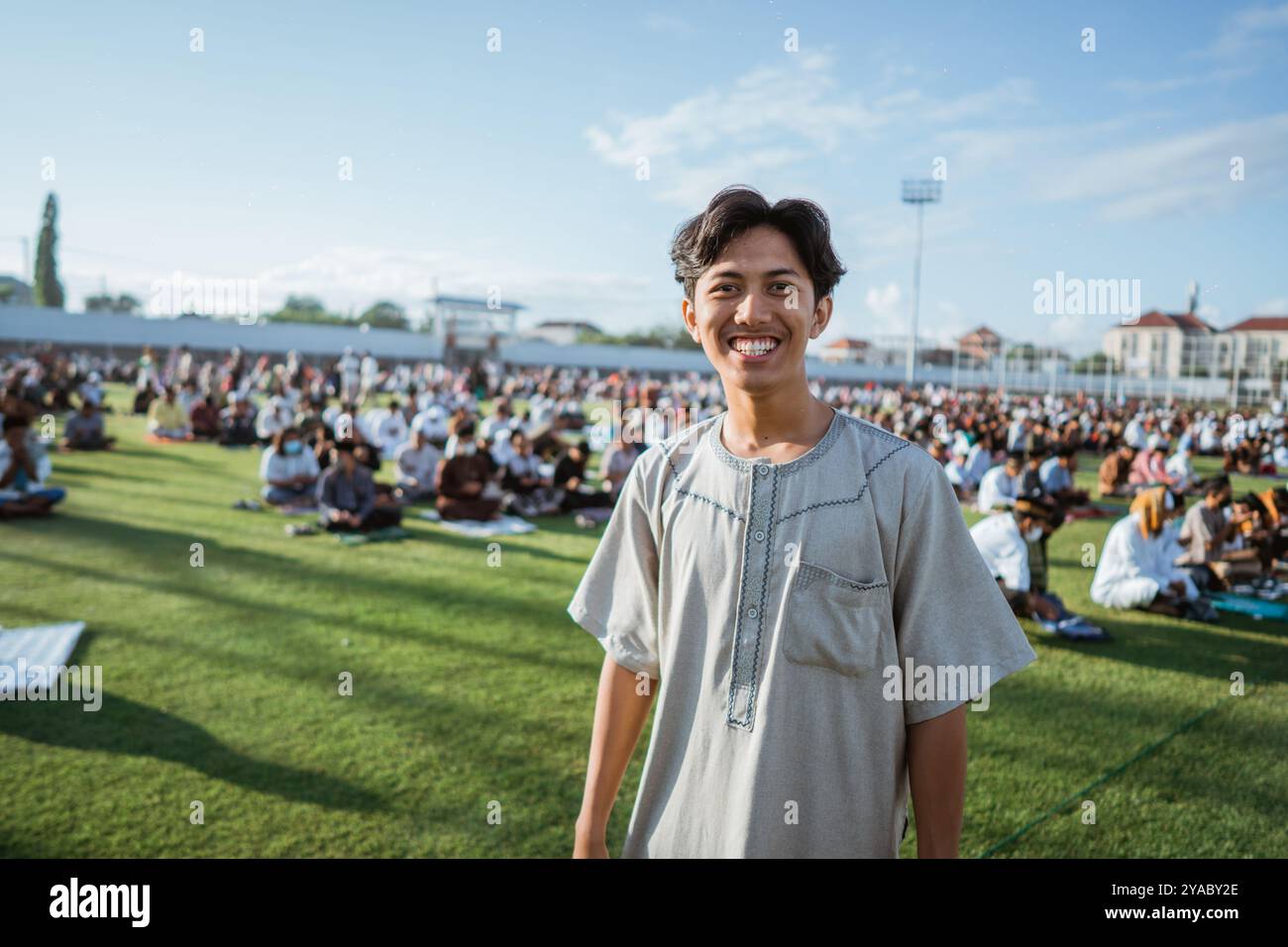 Joyful Gathering: Young Man Smiling Amidst Community Celebration Event ...