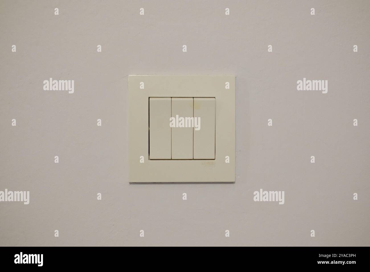 A plain light switch on a white wall Stock Photo - Alamy