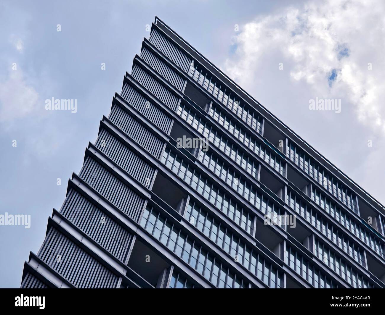 A very tall building that features numerous windows and many balconies ...