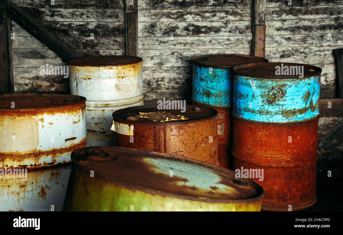 Photography of rusted metal oil drums inside of a work shed Stock Photo ...