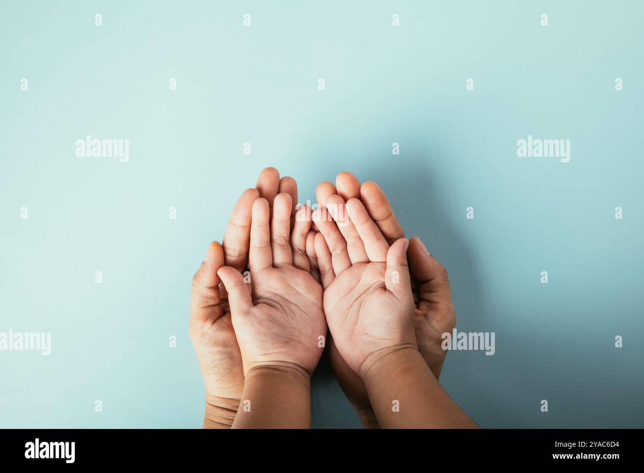 Close-up top view of family hands stack isolated background. Parents ...