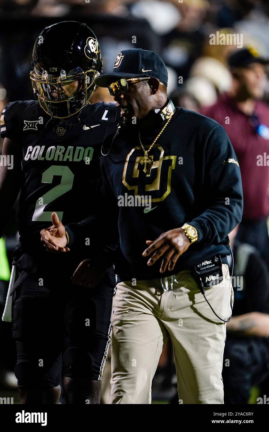 Boulder, CO, USA. 12th Oct, 2024. Colorado Buffaloes head coach Deion Sanders talks to his son ...