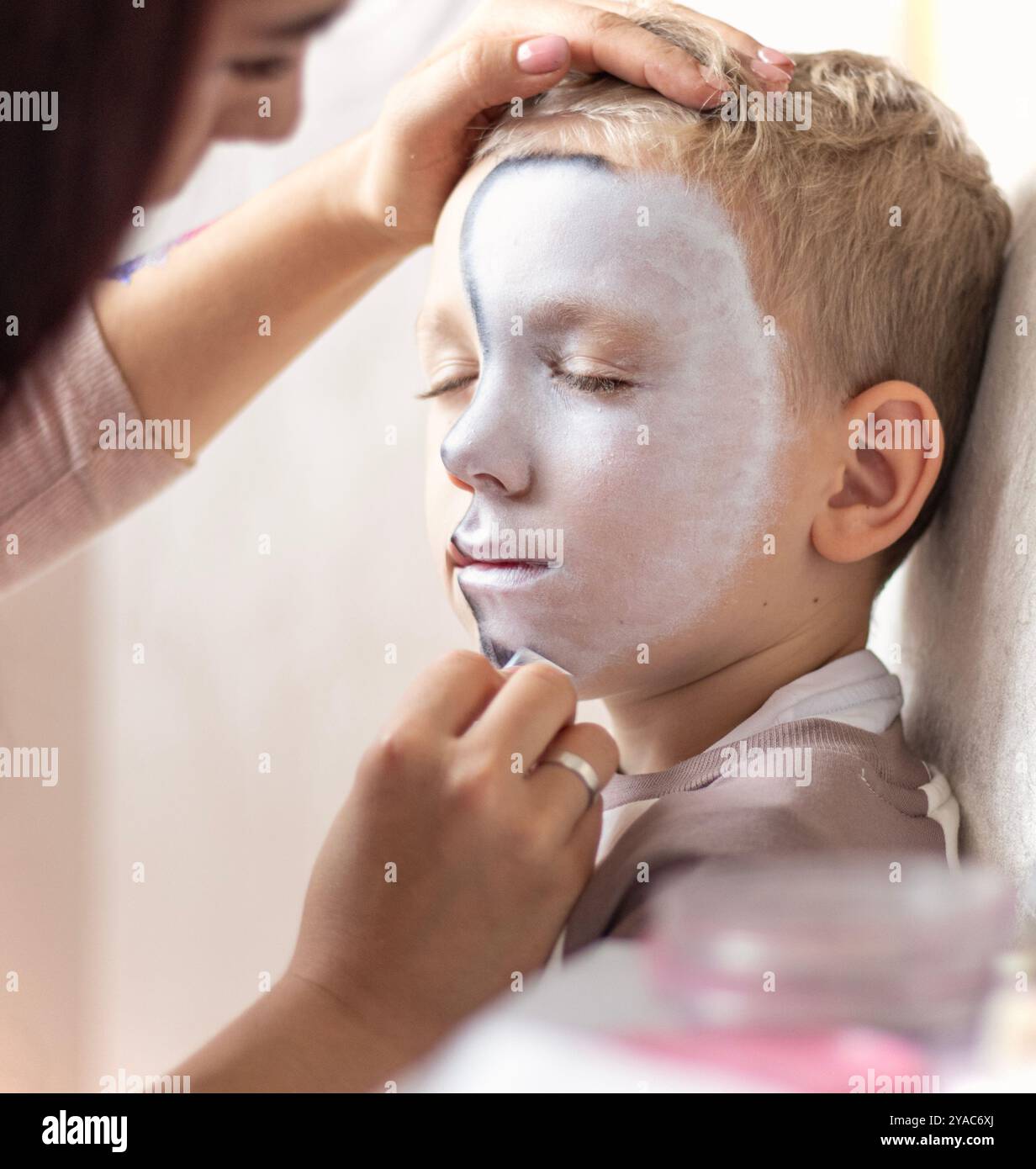 Master making aqua makeup on boys face. face painting kids. child Stock ...