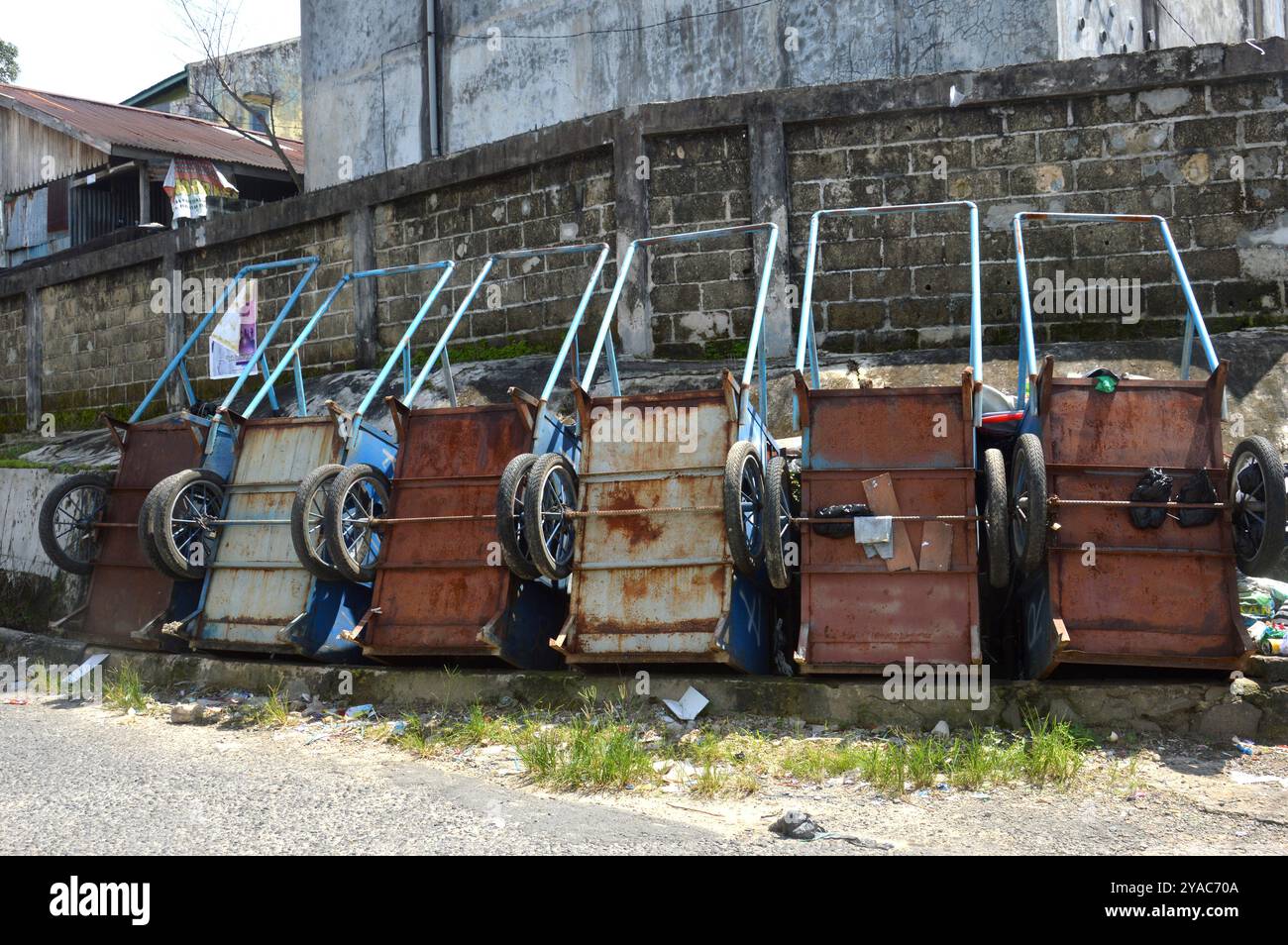 garbage carts on the wall Stock Photo - Alamy