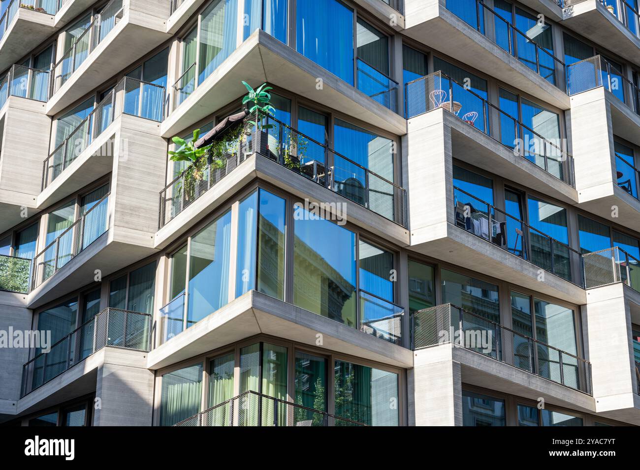 Detail of a modern apartment building with floor-to-ceiling windows ...