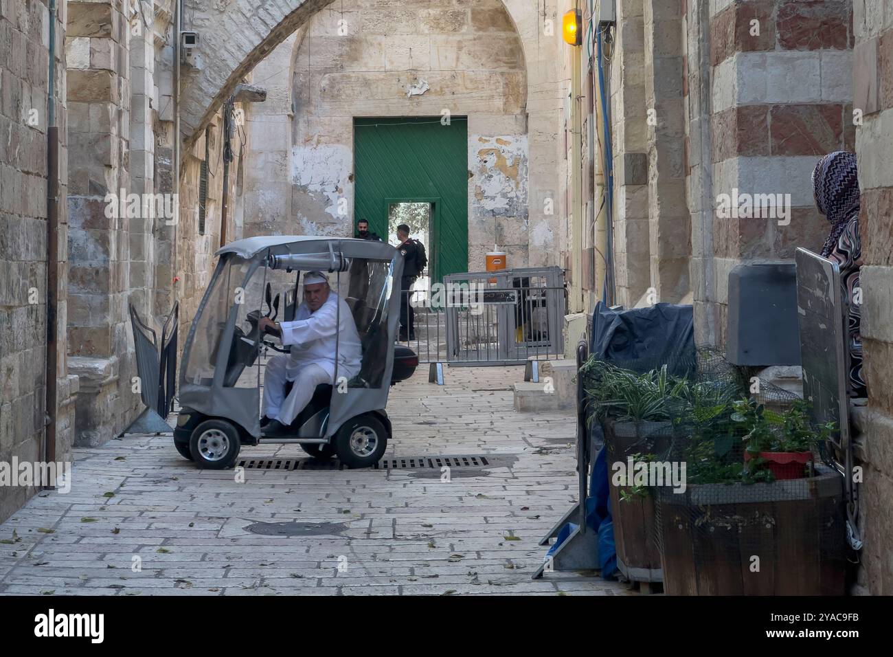 An elderly Palestinian man drives a small electric vehicle at an Bab al ...