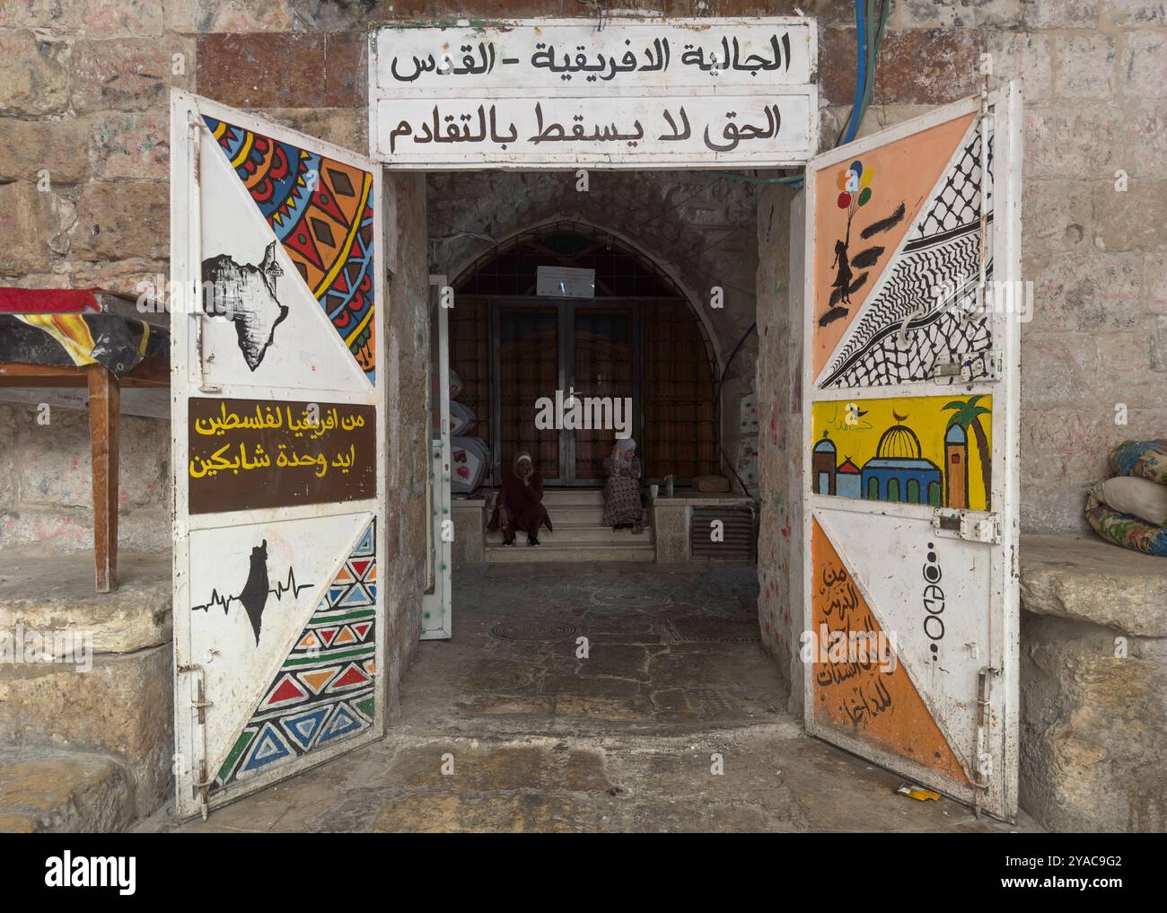 Members of the African community sit at the entrance to a residential ...
