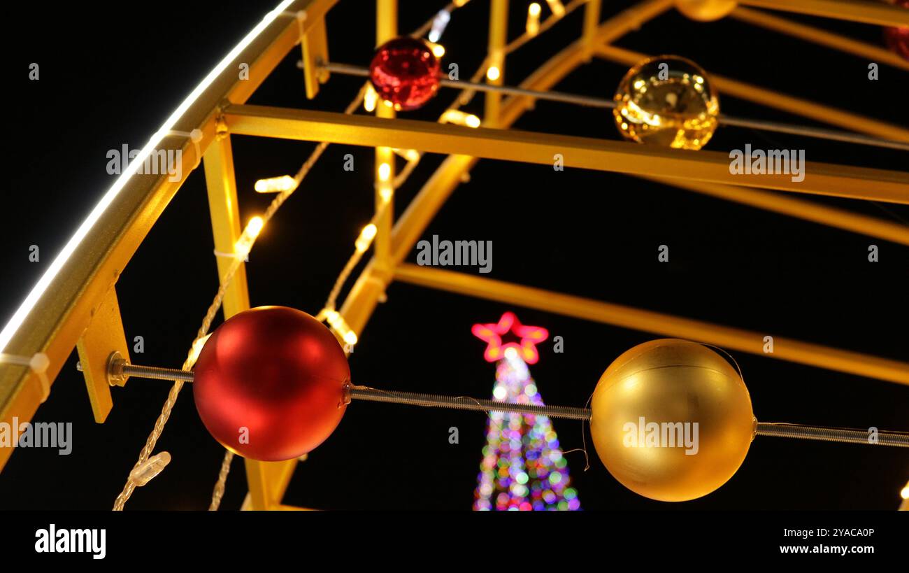 shiny gold and red balls in the structure of the street festive ...
