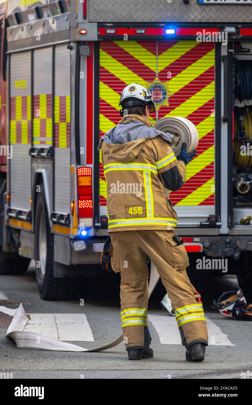 Gothenburg, Sweden - February 25 2023: Firefighter rolling a hose after ...