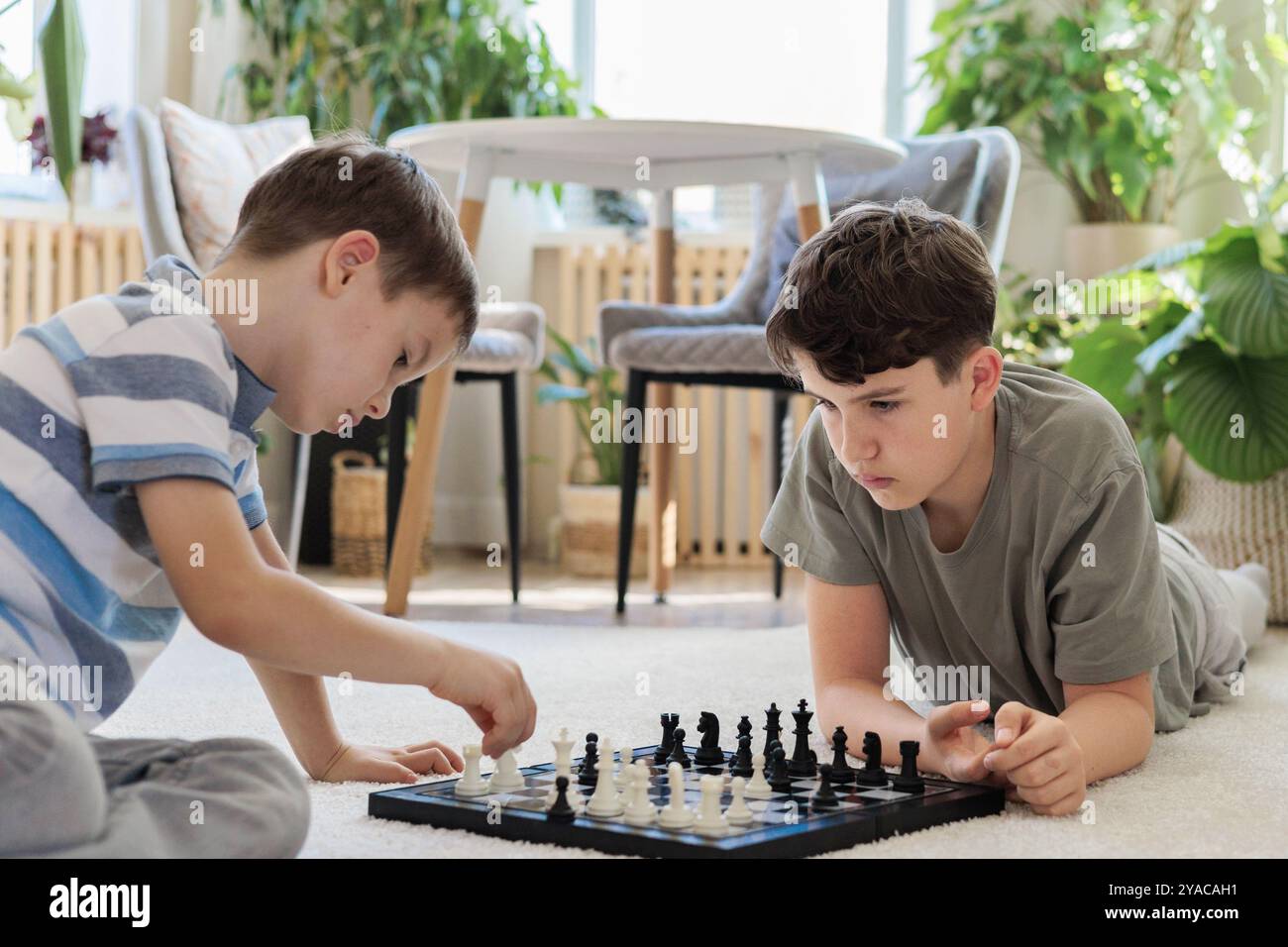 Children brothers play chess hi-res stock photography and images - Alamy