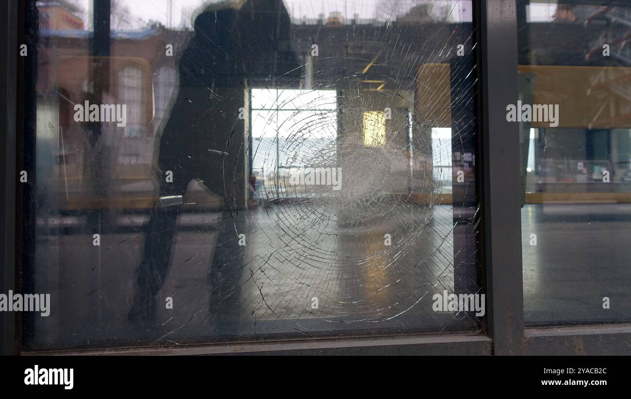 Reflections in a shop window cracked by a violent impact photographed ...