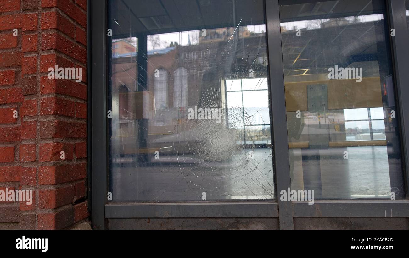 Reflections in a shop window cracked by a violent impact photographed ...