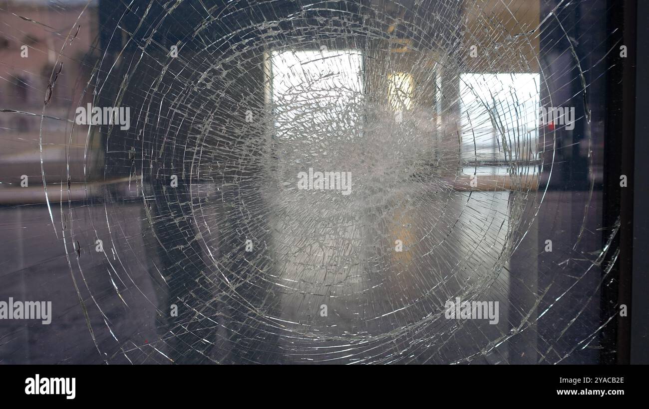 Reflections in a shop window cracked by a violent impact photographed ...