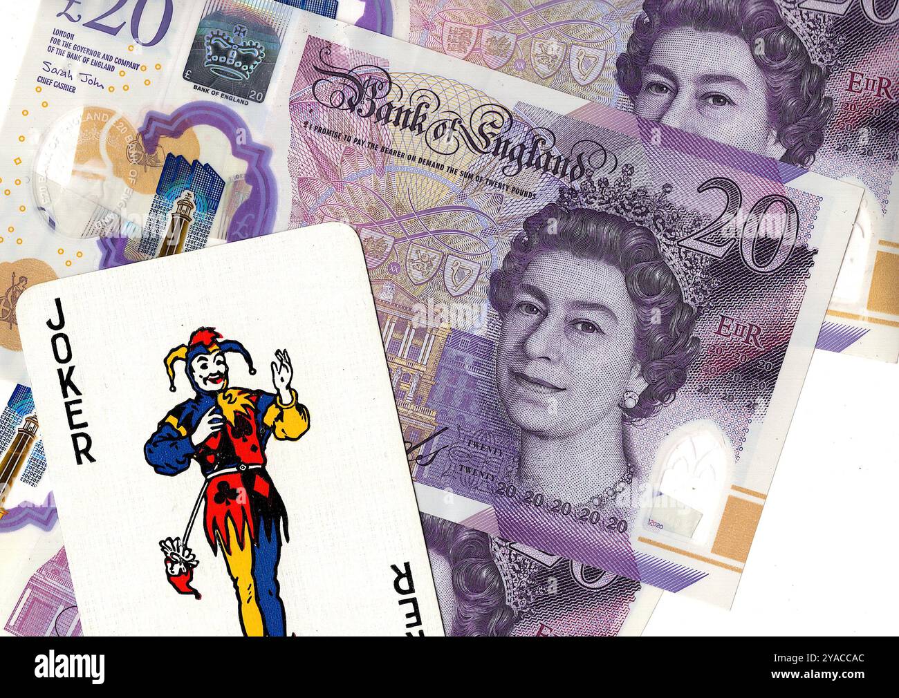 A joker playing card and twenty pound banknotes from the United Kingdom ...