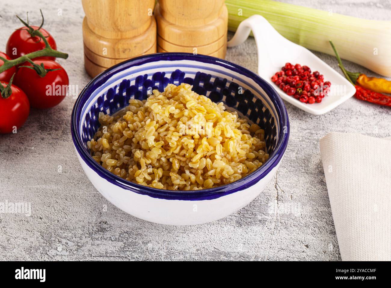 Boiled bulgur wheat in the bowl garnish Stock Photo - Alamy