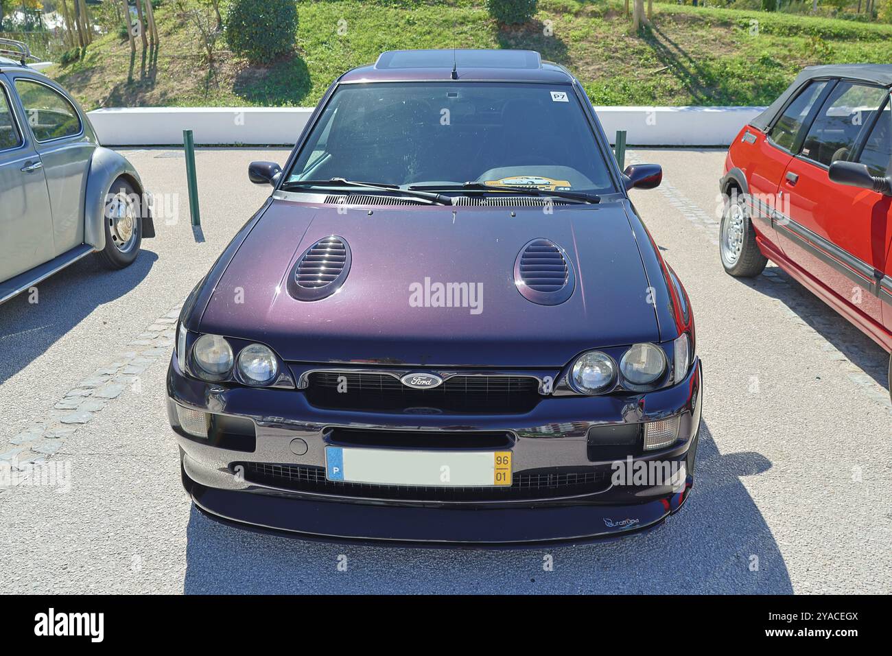Ford escort rs cosworth is parked up, showing off its iconic front end ...