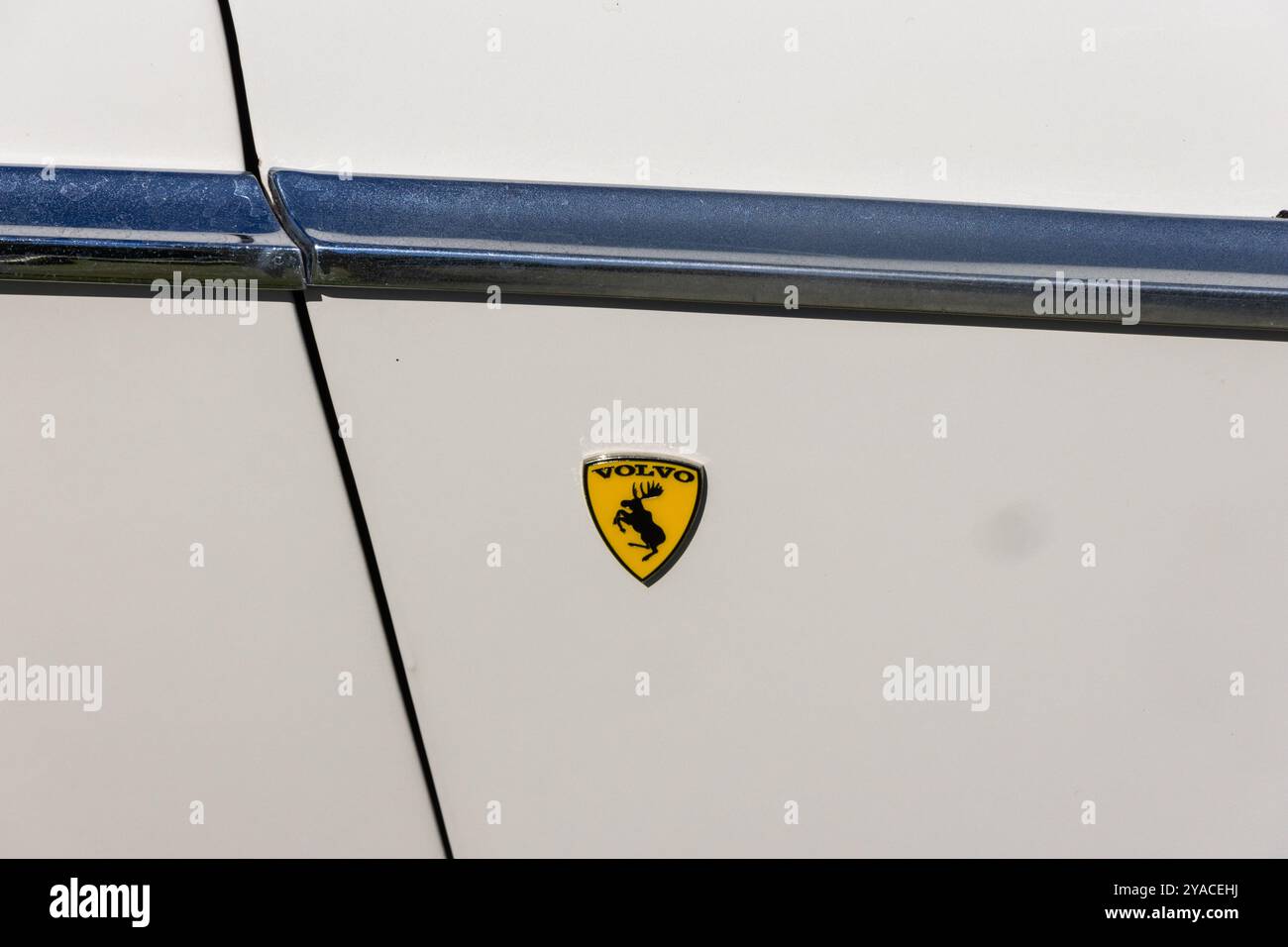 The iconic volvo logo is shining on the side of a vintage white volvo ...