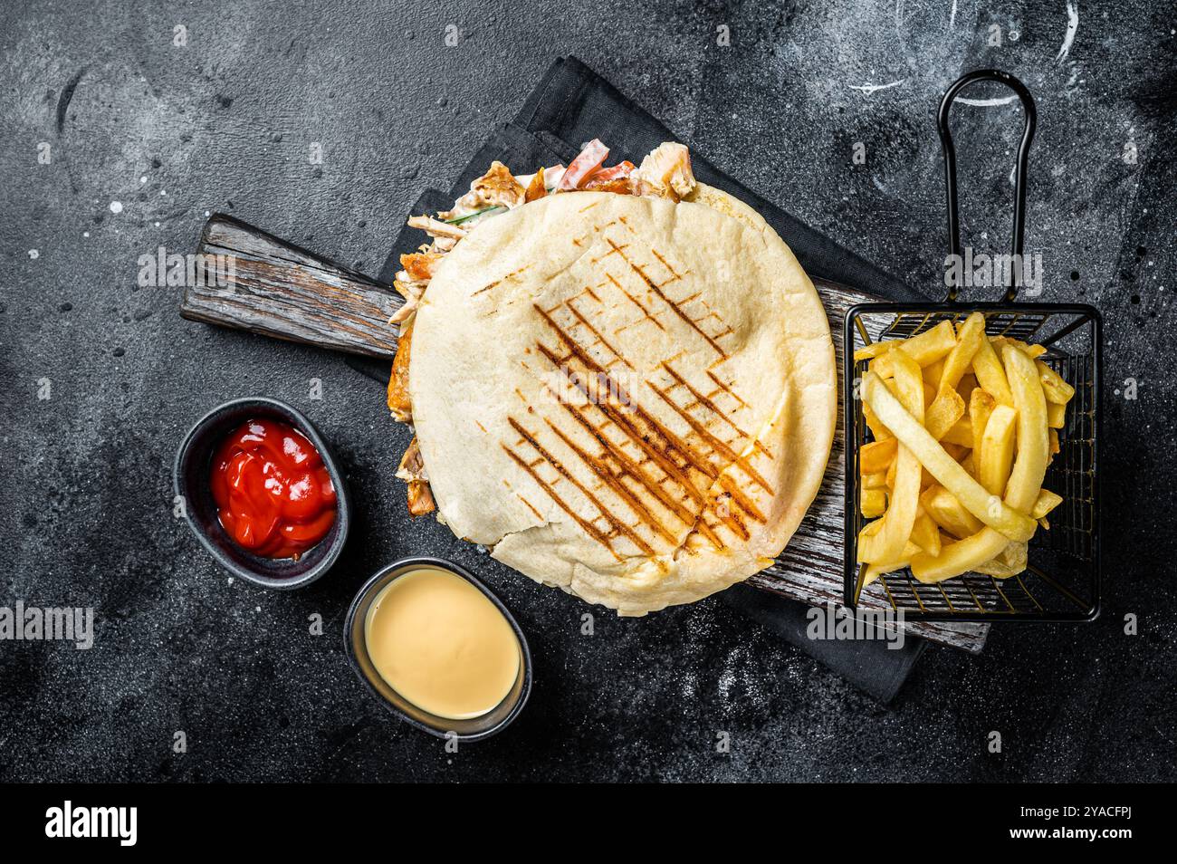 Turkish doner kebab in grilled pita bread with chicken meat. Black ...