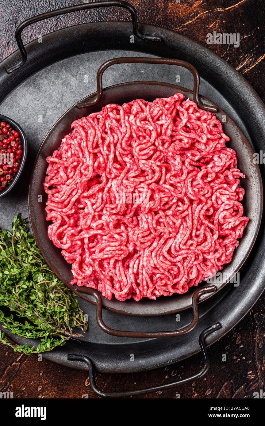 Raw Mince, minced Ground beef meat in a kitchen tray. Dark background ...