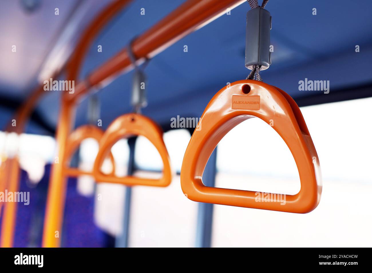 Handles for passengers on a bus Stock Photo - Alamy