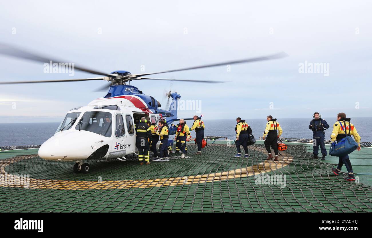 Oil and gas workers leaveto go home by helicopter on an oil rig in the ...