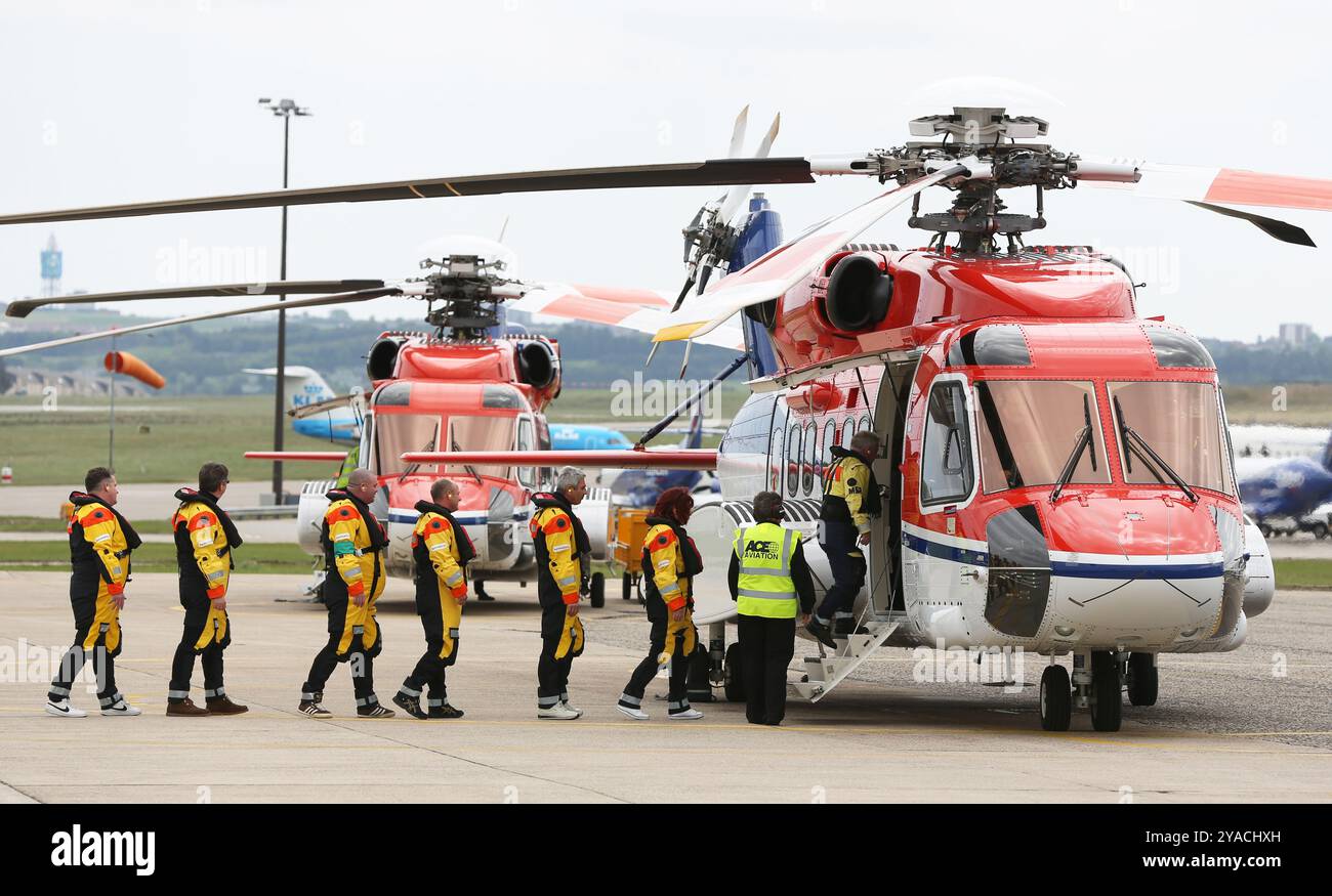 Oil and gas workers board a helicopter at aberdeen airport to go ...