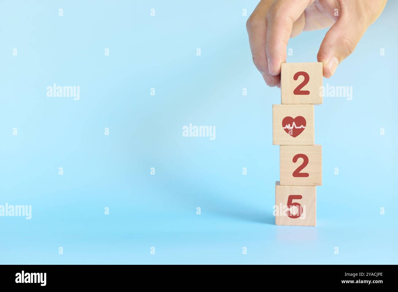 Year 2025 health priority concept. Wooden blocks on blue background ...