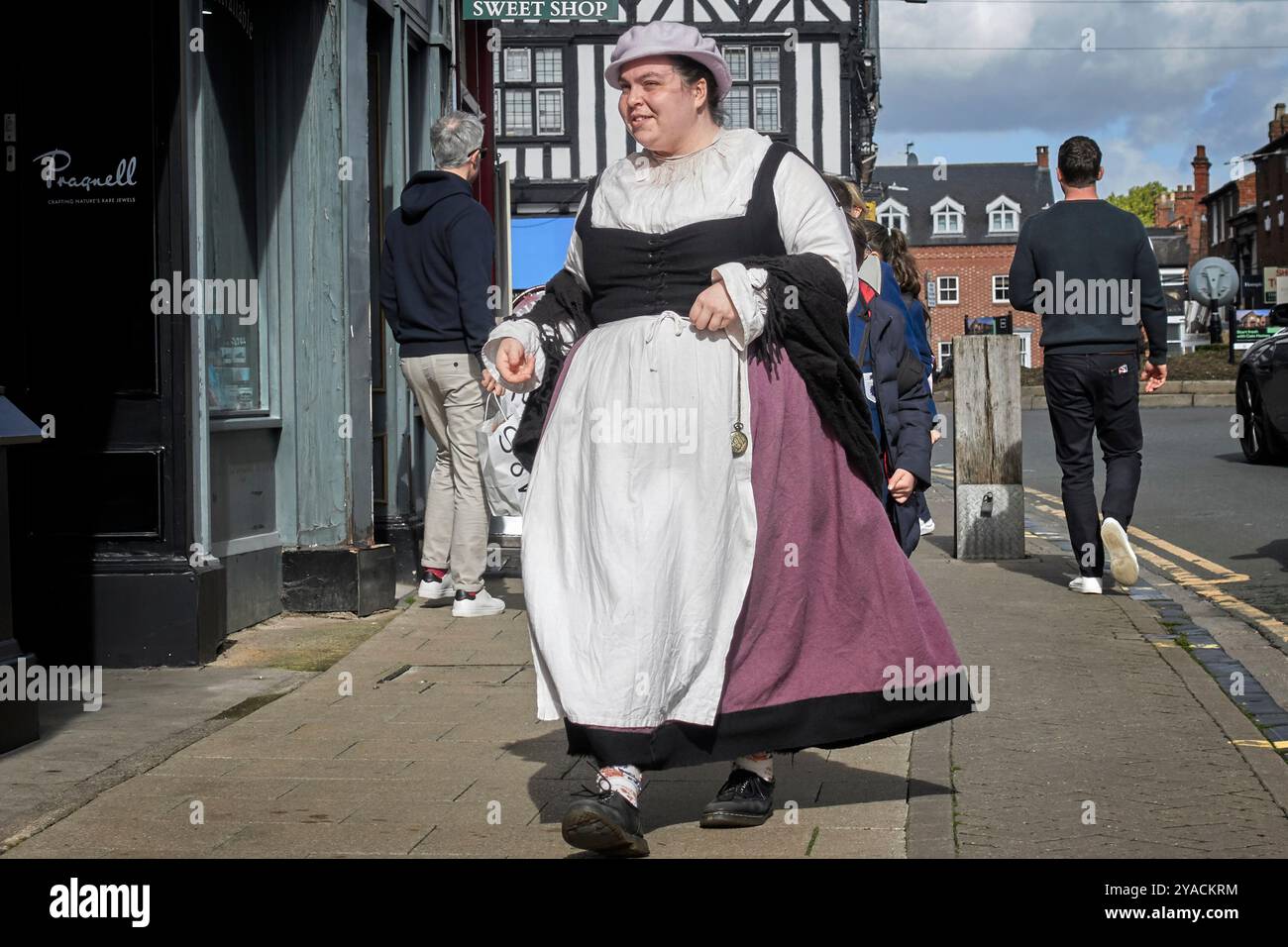 Tour guide UK. Woman in traditional Tudor. Tourist attraction ...