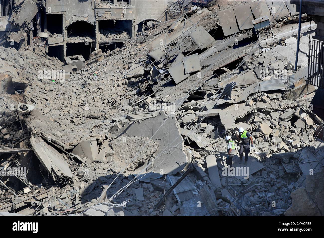 Hezbollah rescue workers search for victims amidst the rubble of ...