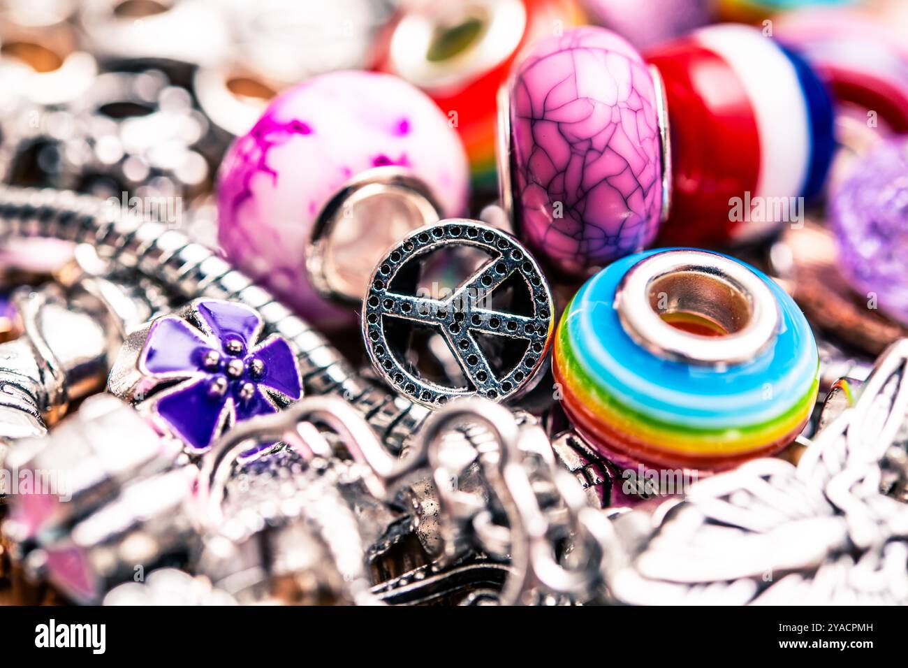 Colorful charms featuring a silver peace sign, perfect for creative ...
