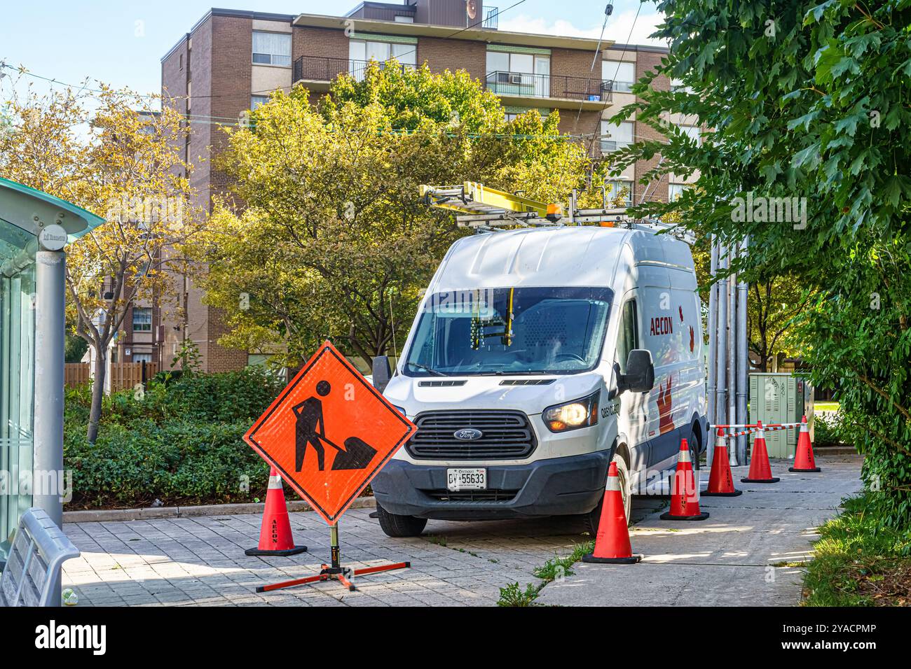 A van branded with the Aecon logo parked beside a sign indicating ...