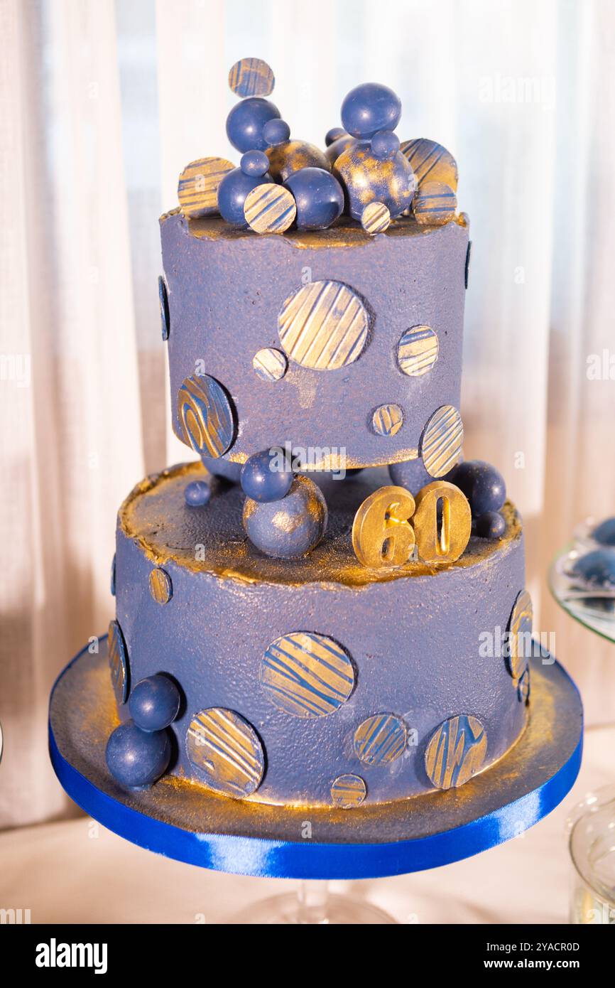 Elegant Two-Tier Birthday Cake With Blue and Gold Decorations for a ...