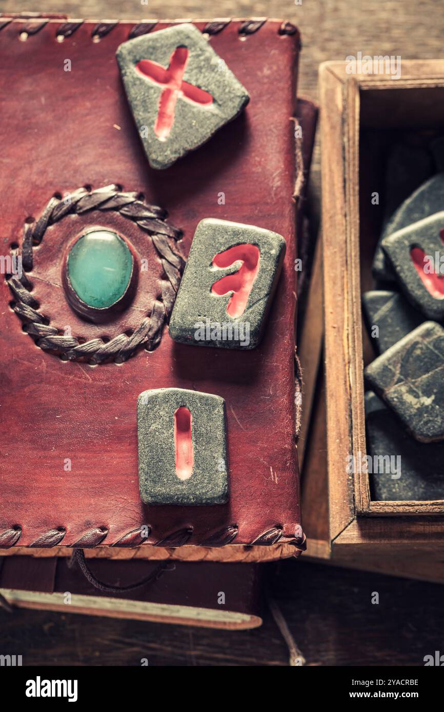 Vintage rune stones using old Celtic language and leather book as a ...