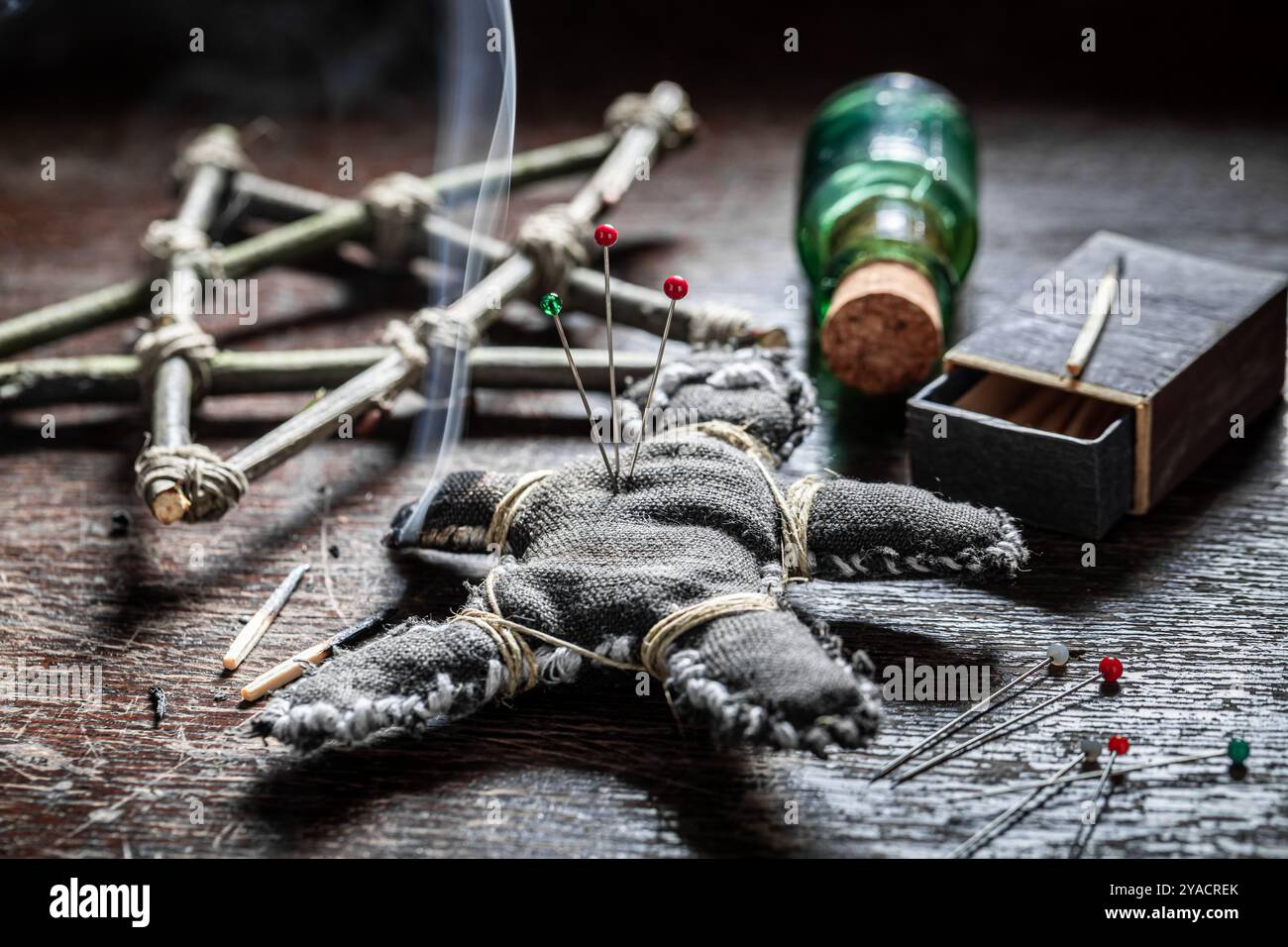 Scary voodoo doll burned with fire and pierced by a needle as a ...