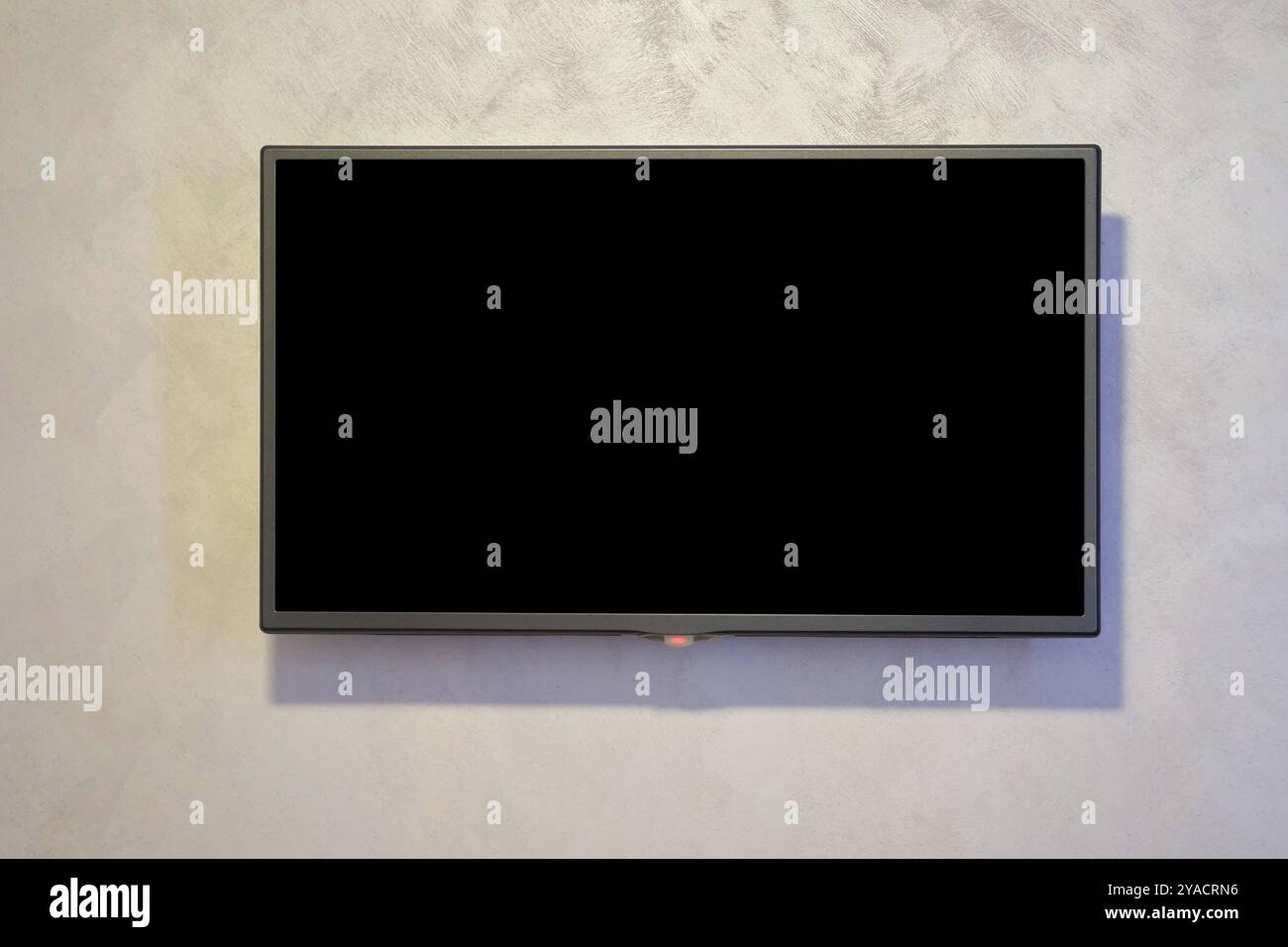 Black TV screen hanging on the wall. Rectangular television on the wall ...