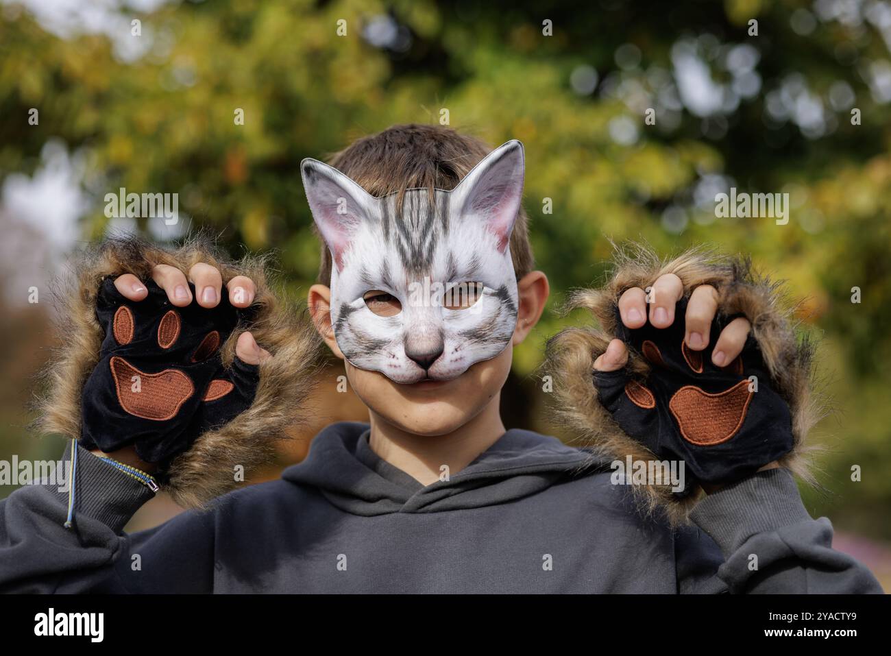 Teenager in a cat mask and gloves doing Quadrobics . aggressive ...