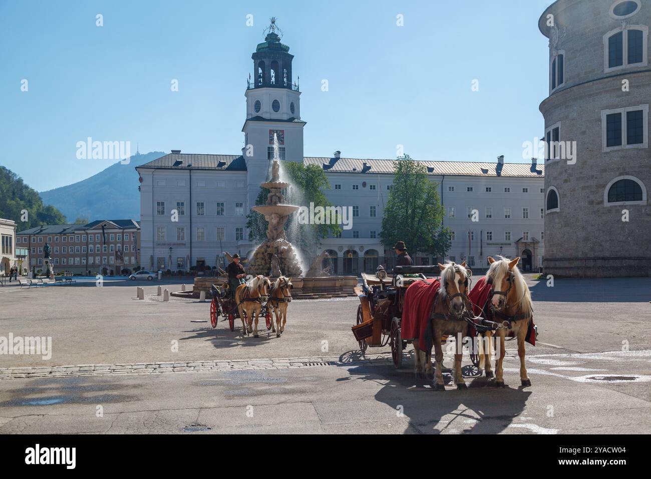 A charriot with horses at the Residenzplatz square with the ...