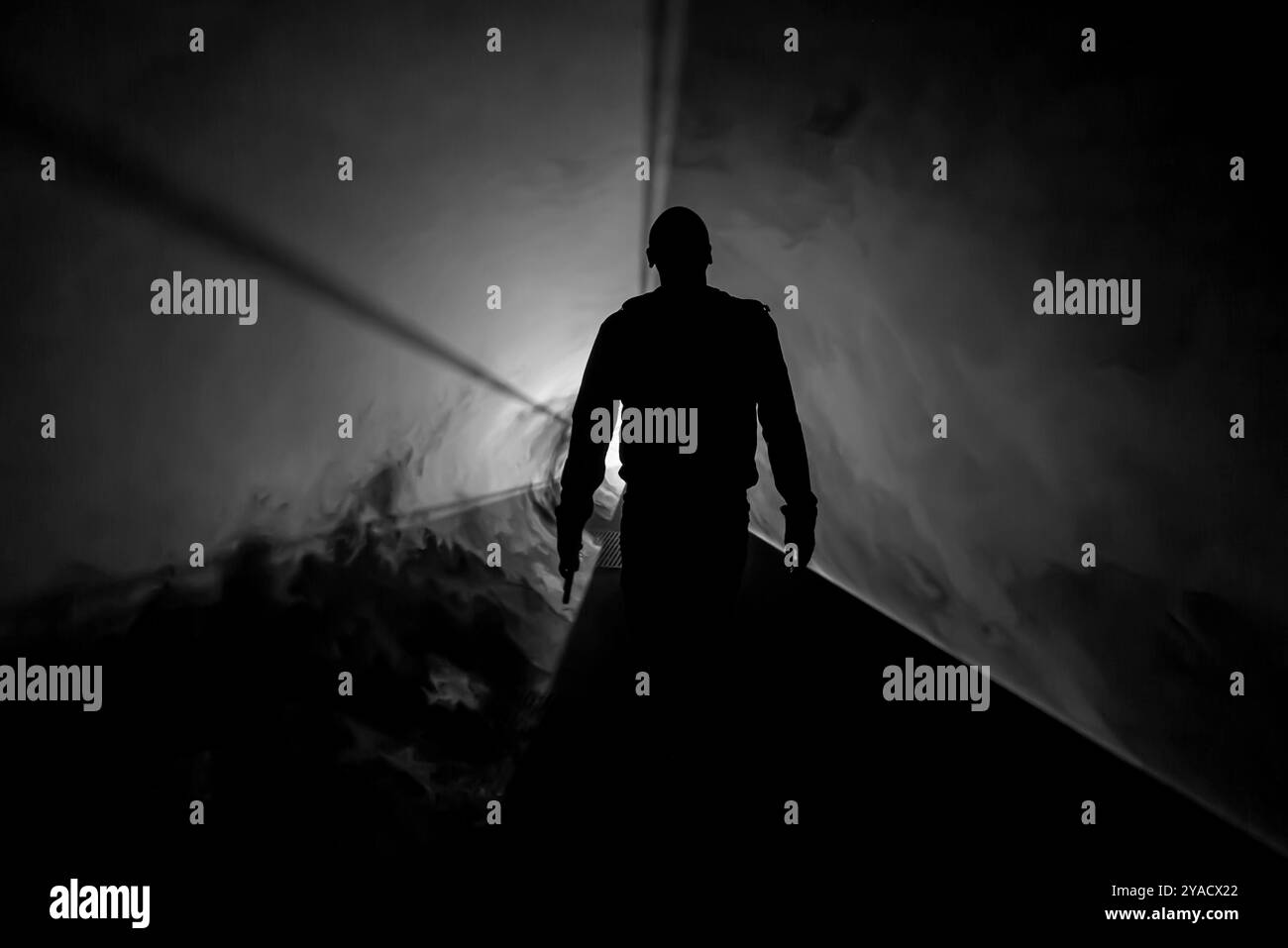 A silhouette of a man with what looks like a gun in his hand Stock ...