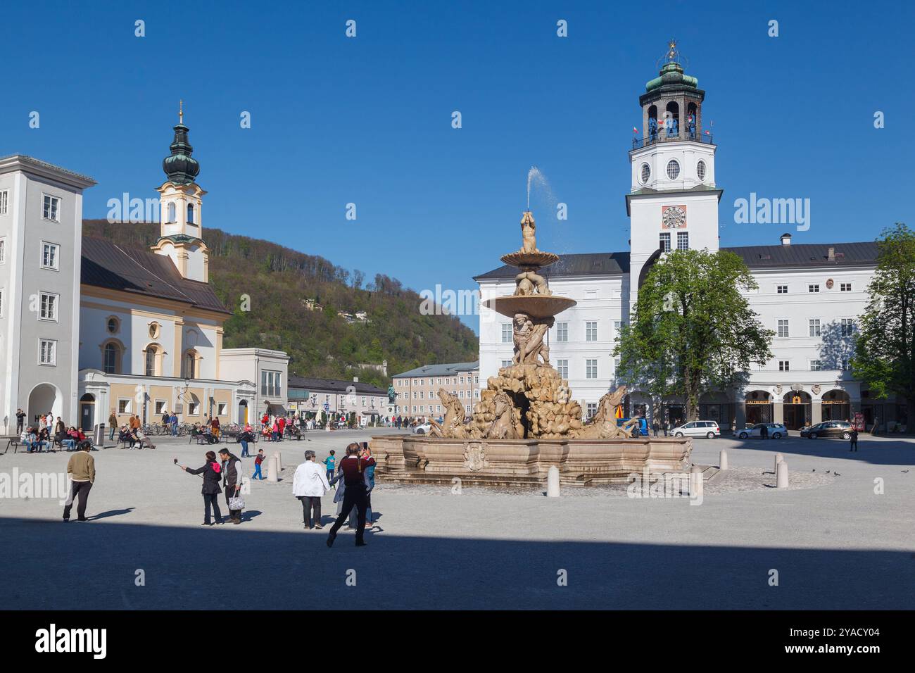 The Fountain and Salzburg Museum with its clock tower at Residentzplatz ...